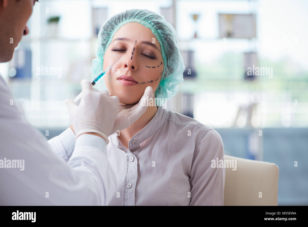 Plastic surgeon preparing for operation on woman face Stock Photo - Alamy