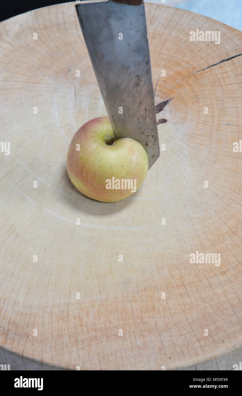 knife cut apple on wooden chop block Stock Photo - Alamy
