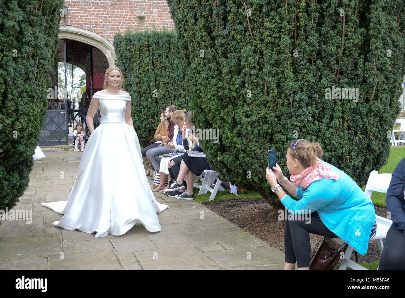 Beautiful Models wearing Bridal wear are walking on a catwalk at ...