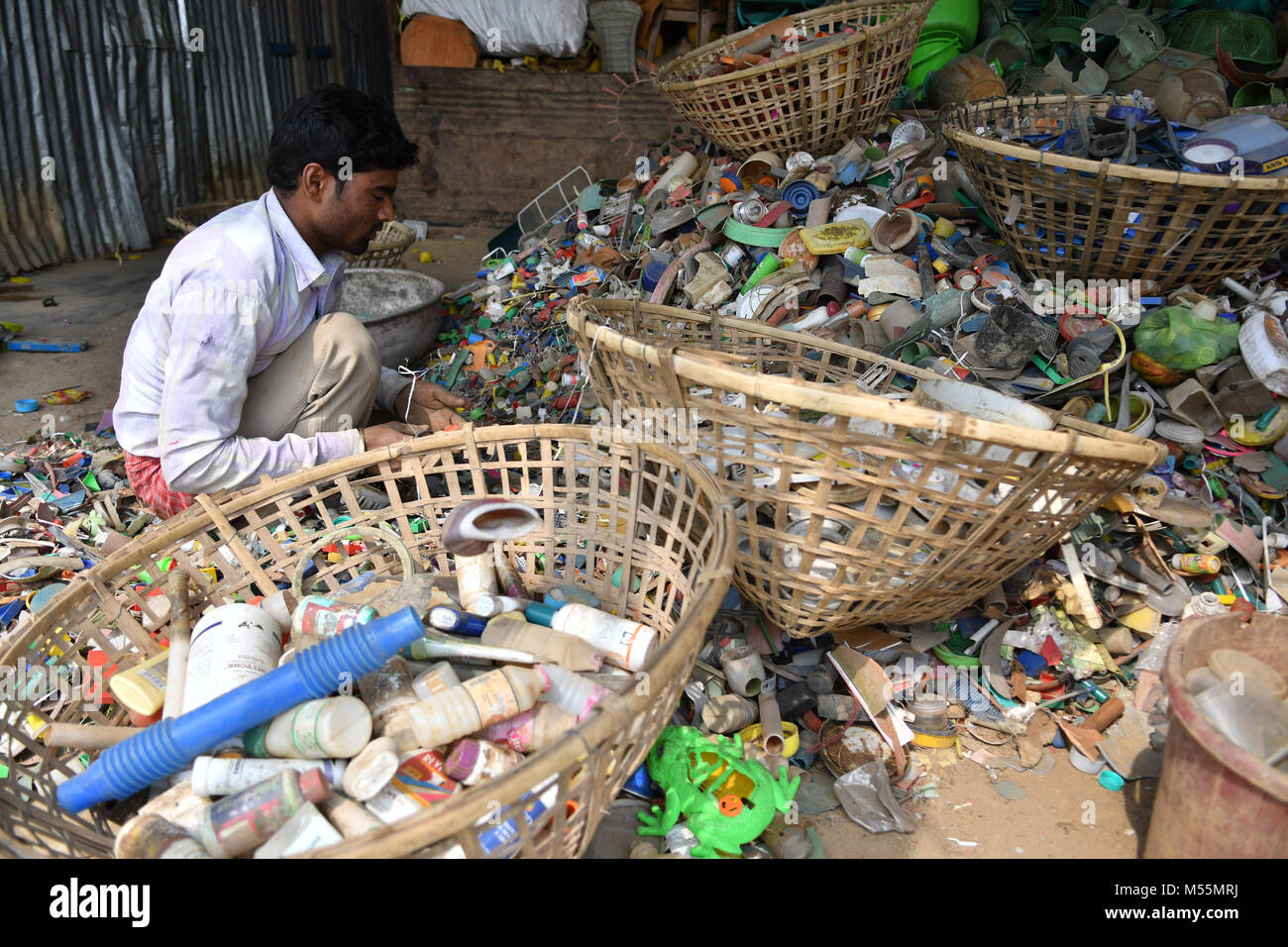 Tripura, India. 20th Feb, 2018. A man works in a plastic recycle ...