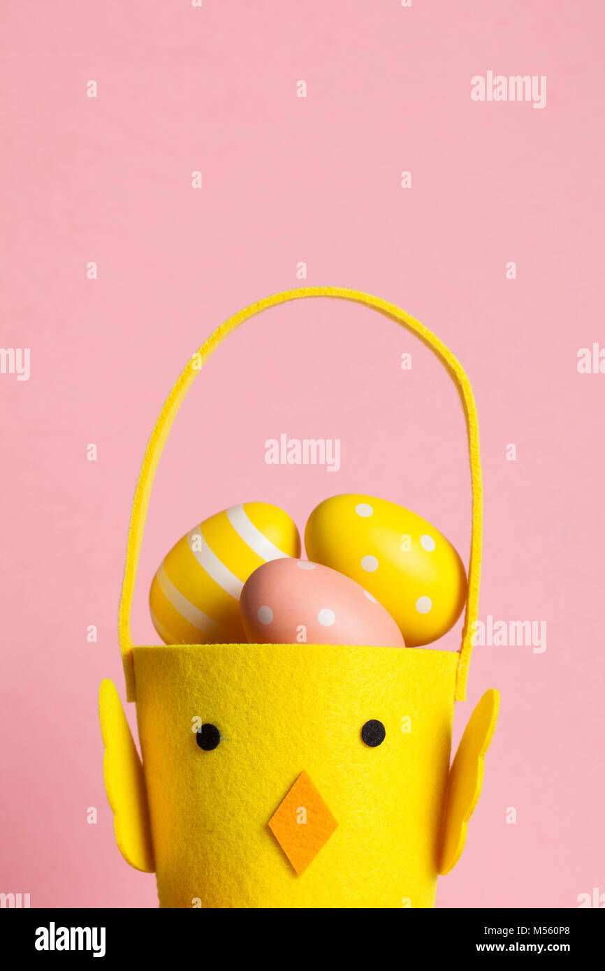 Yellow easter chick basket full of easter eggs Stock Photo - Alamy