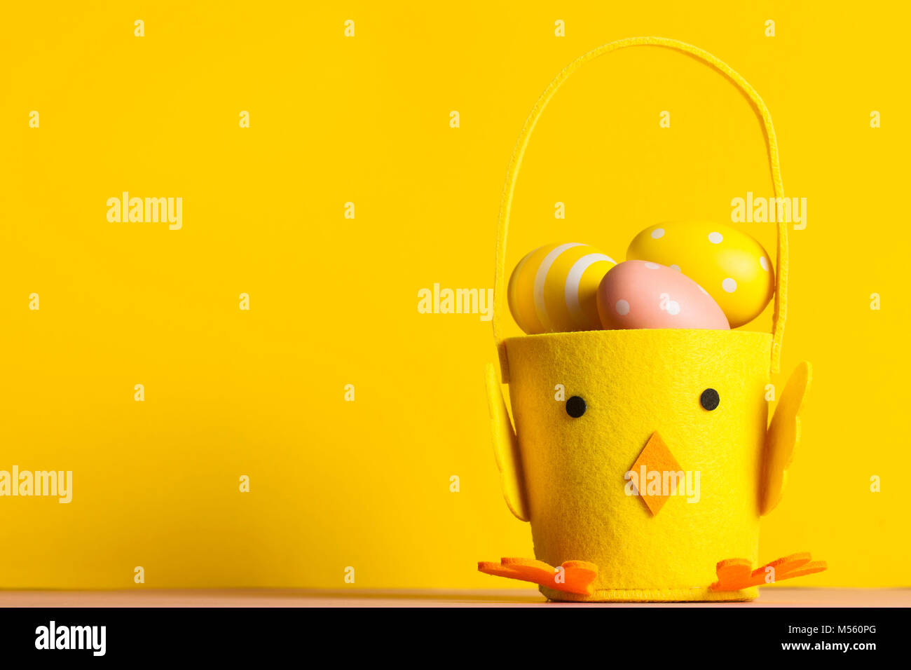 Yellow easter chick basket full of easter eggs Stock Photo - Alamy