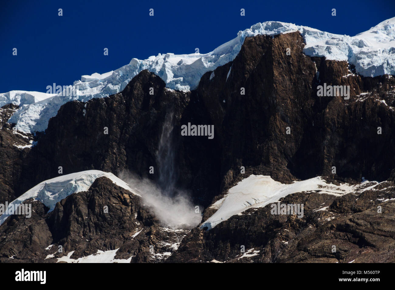 A large chunk of ice just calved off the face of the hanging glacier ...