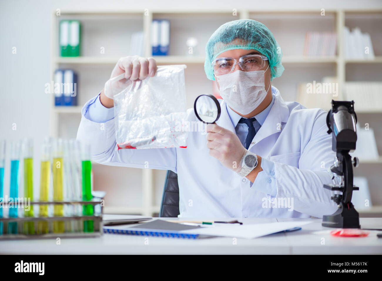 Forensics investigator working in lab on crime evidence Stock Photo - Alamy