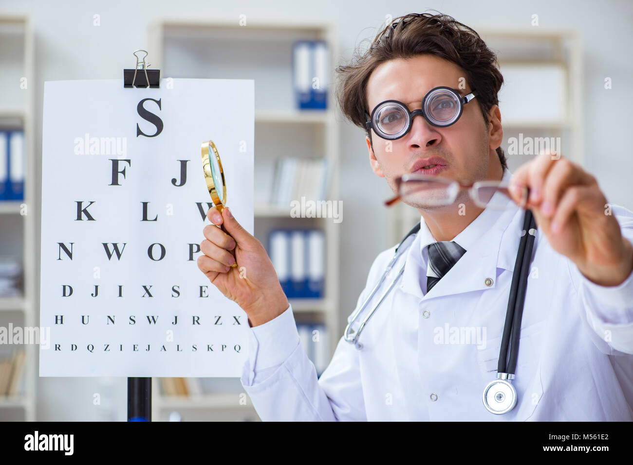 Funny eye doctor in humourous medical concept Stock Photo - Alamy