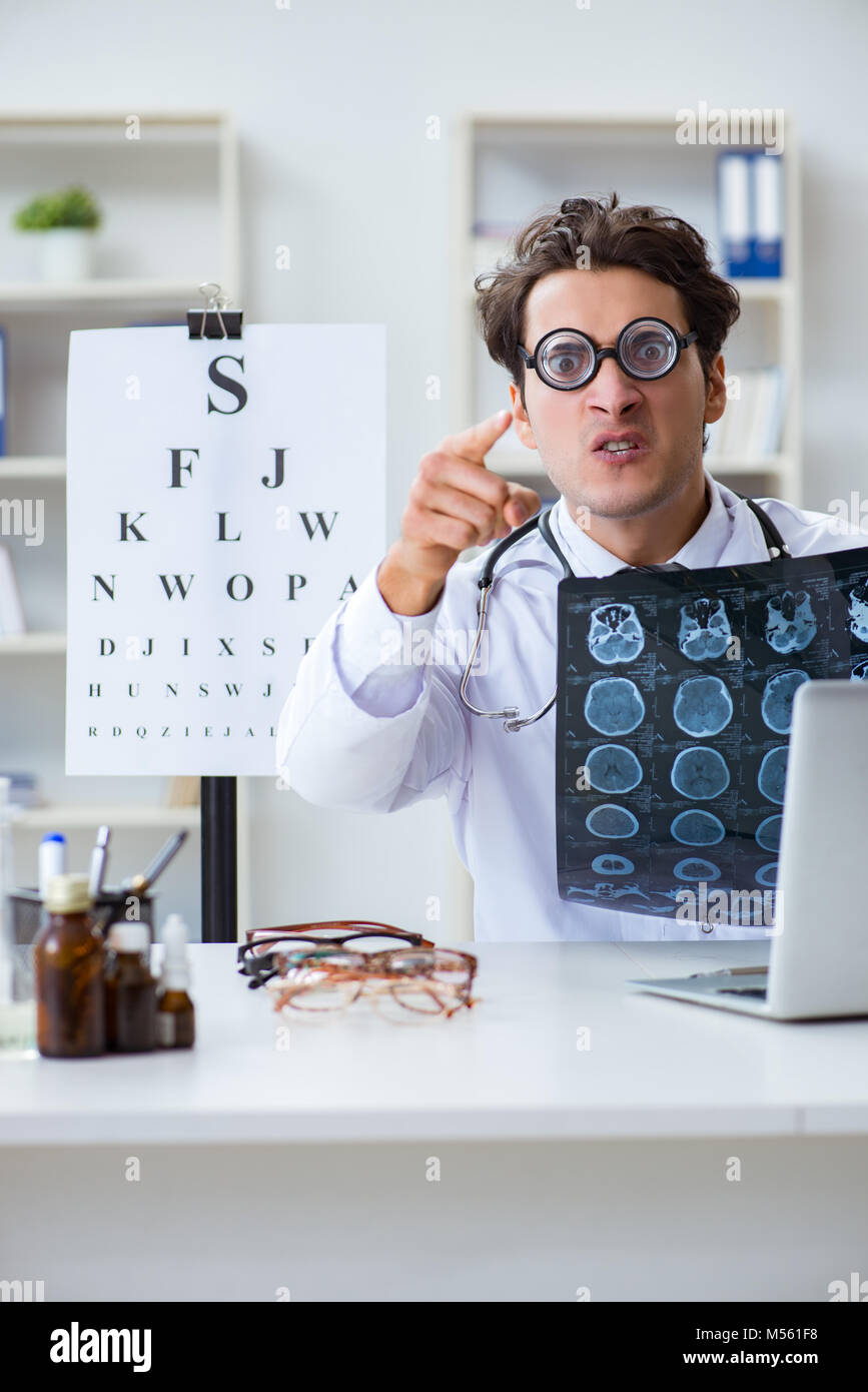 Funny eye doctor in humourous medical concept Stock Photo - Alamy