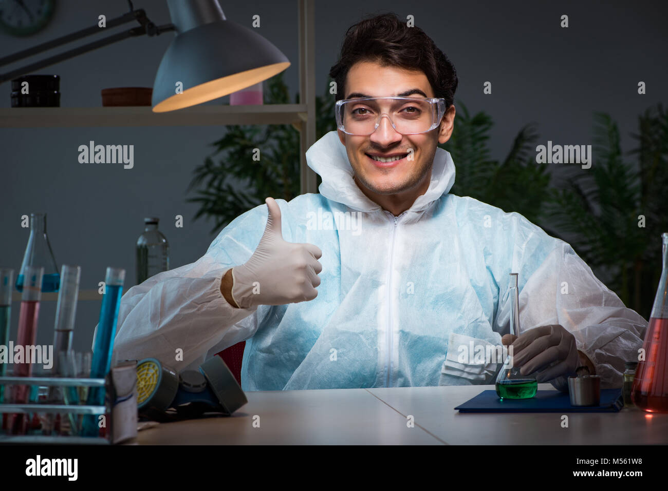 Young male lab chemist late at night in overtime time Stock Photo - Alamy