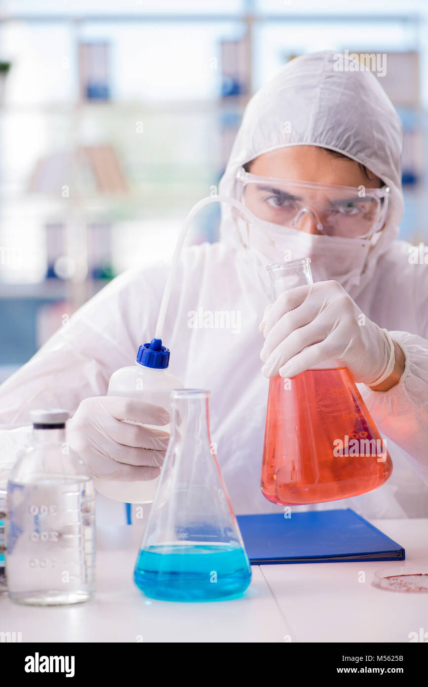 The chemist working in the laboratory with hazardous chemicals Stock ...