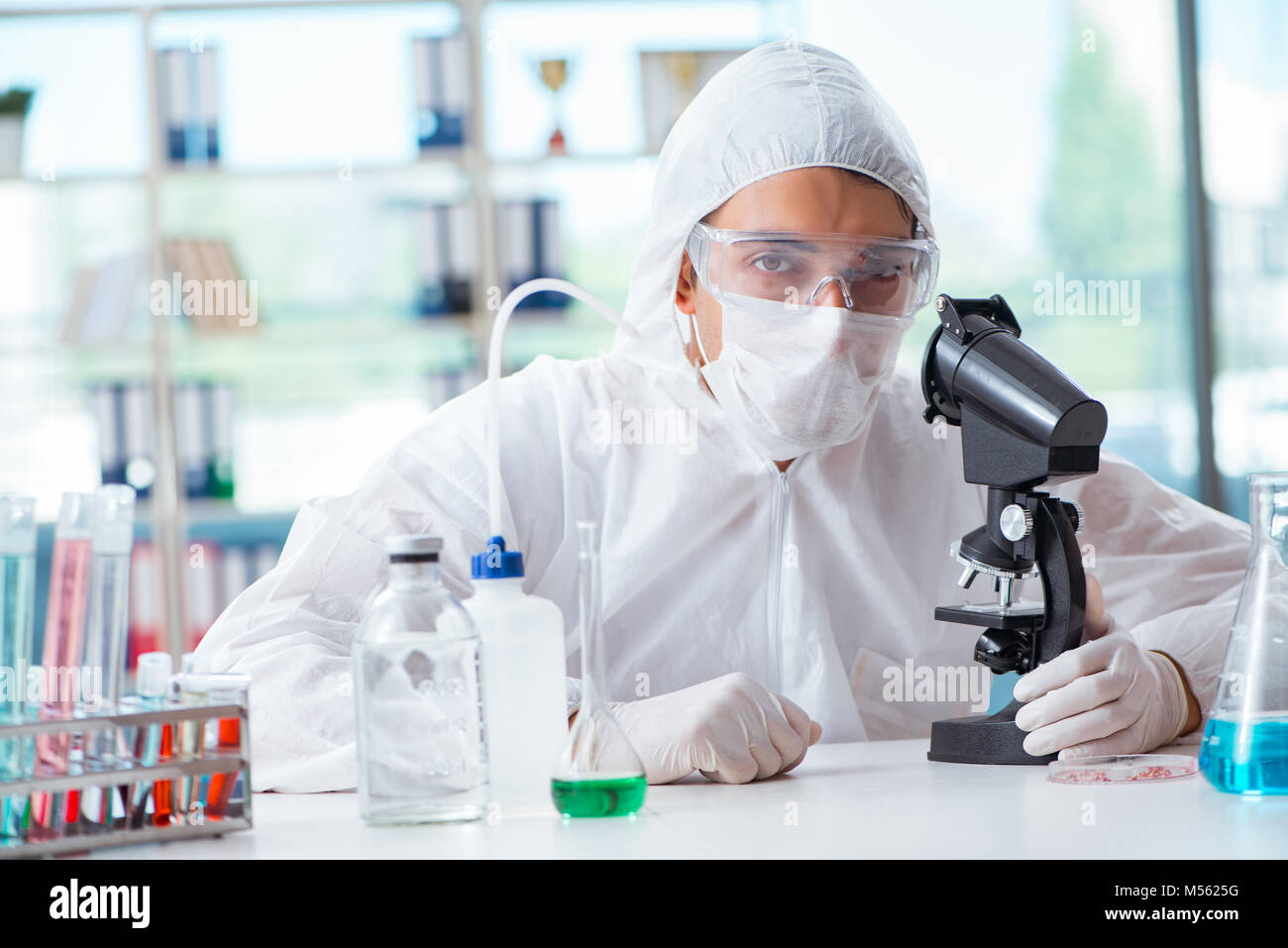 The chemist working in the laboratory with hazardous chemicals Stock ...