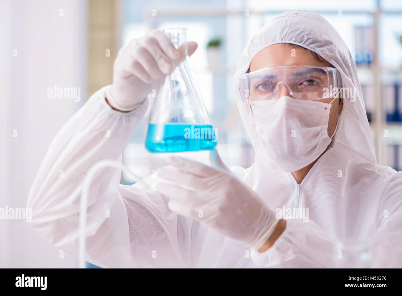 The chemist working in the laboratory with hazardous chemicals Stock ...