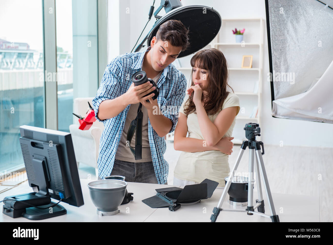 Young photographer working in photo studio Stock Photo - Alamy