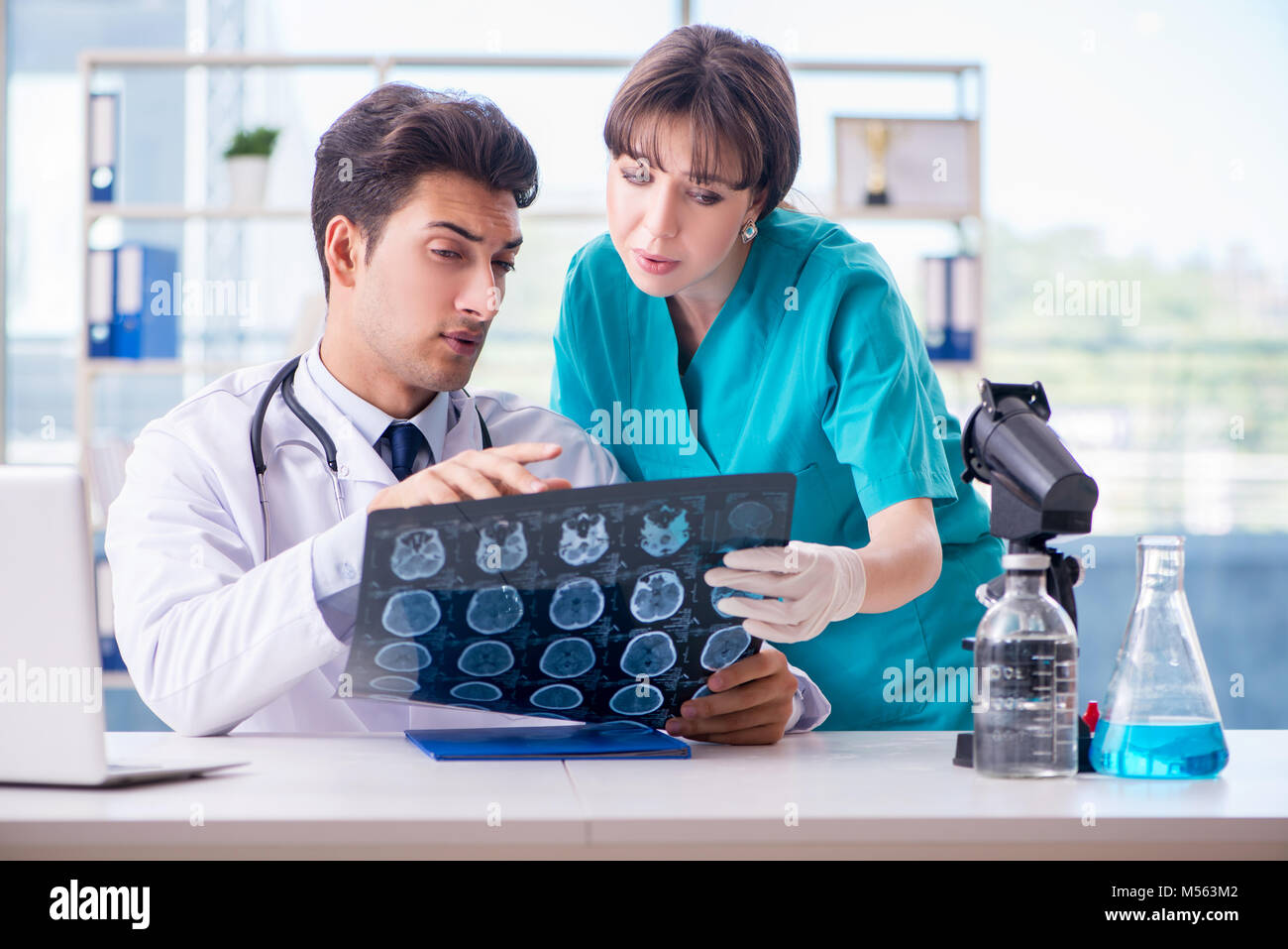 Two doctors discussing x-ray MRI image in hospital Stock Photo - Alamy