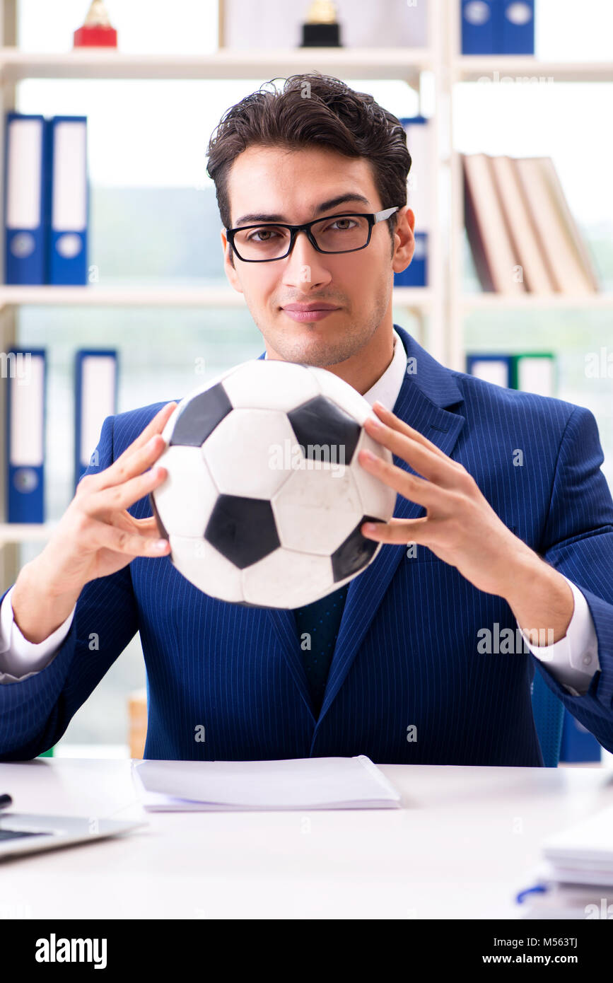 Businessman playing football in the office Stock Photo - Alamy