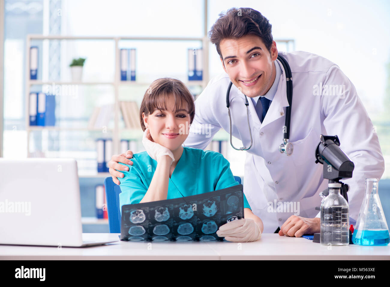 Two doctors discussing x-ray MRI image in hospital Stock Photo - Alamy