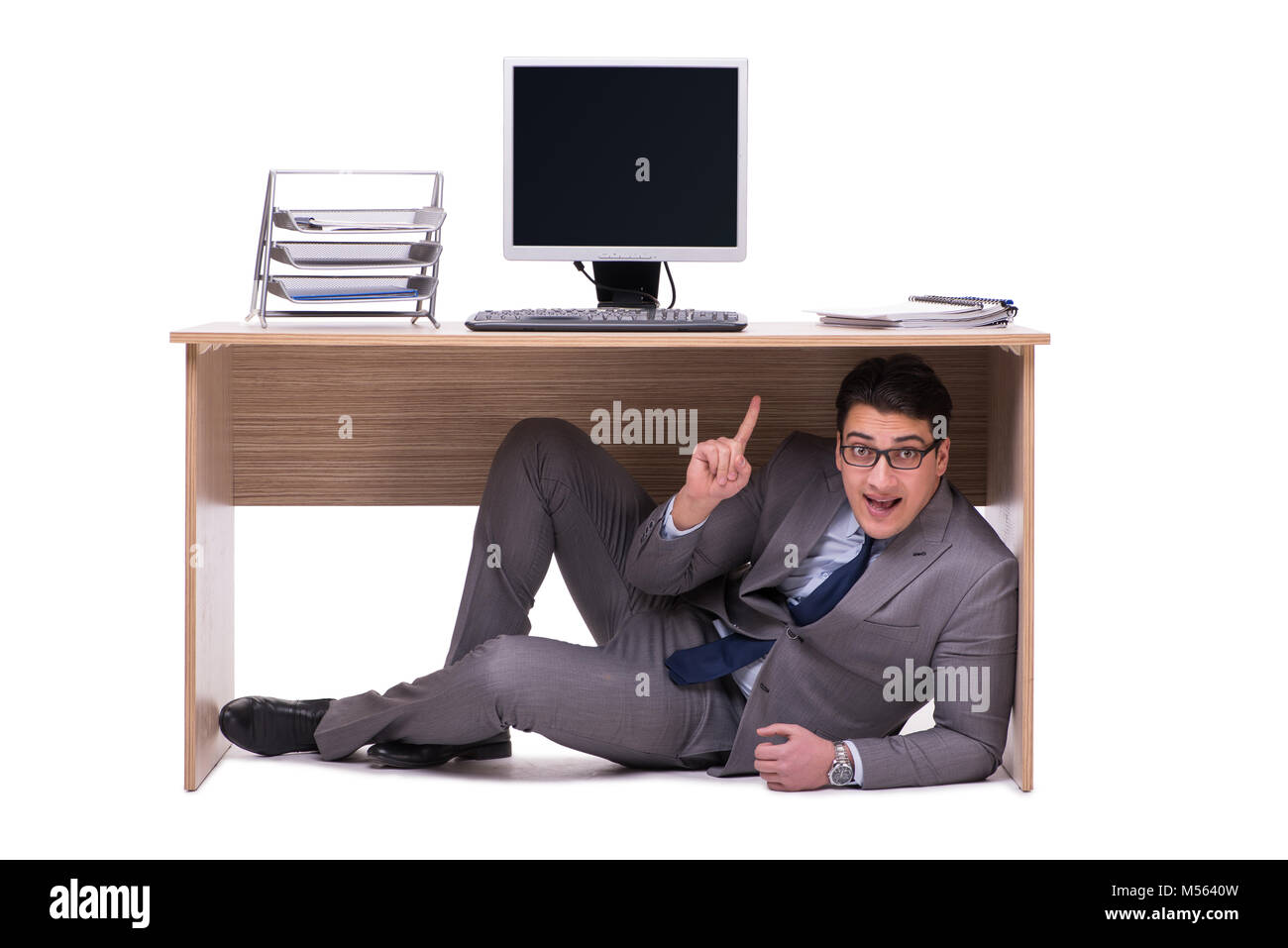 Person hiding under desk Cut Out Stock Images & Pictures - Alamy