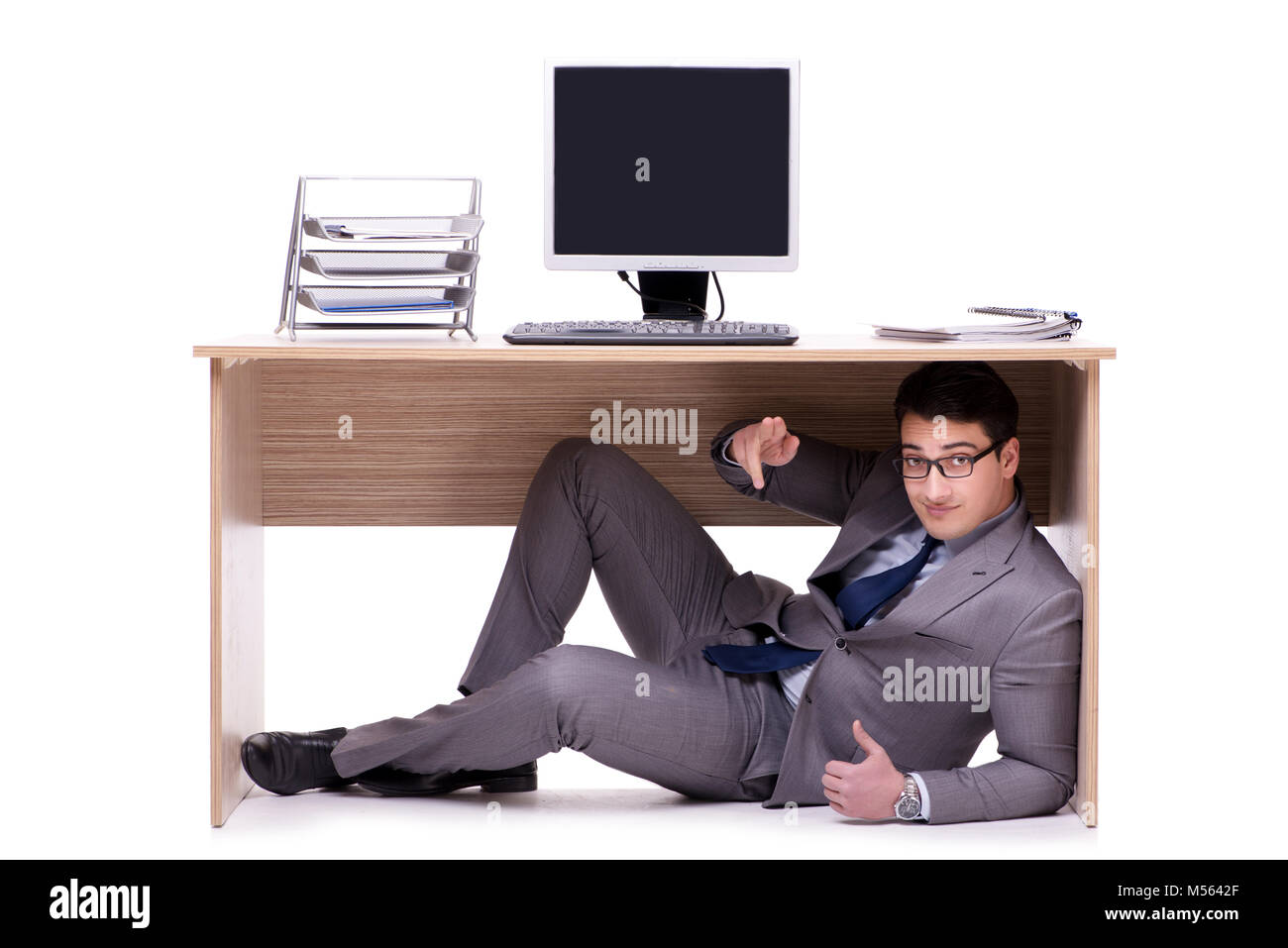 Businessman hiding in the ofice Stock Photo - Alamy