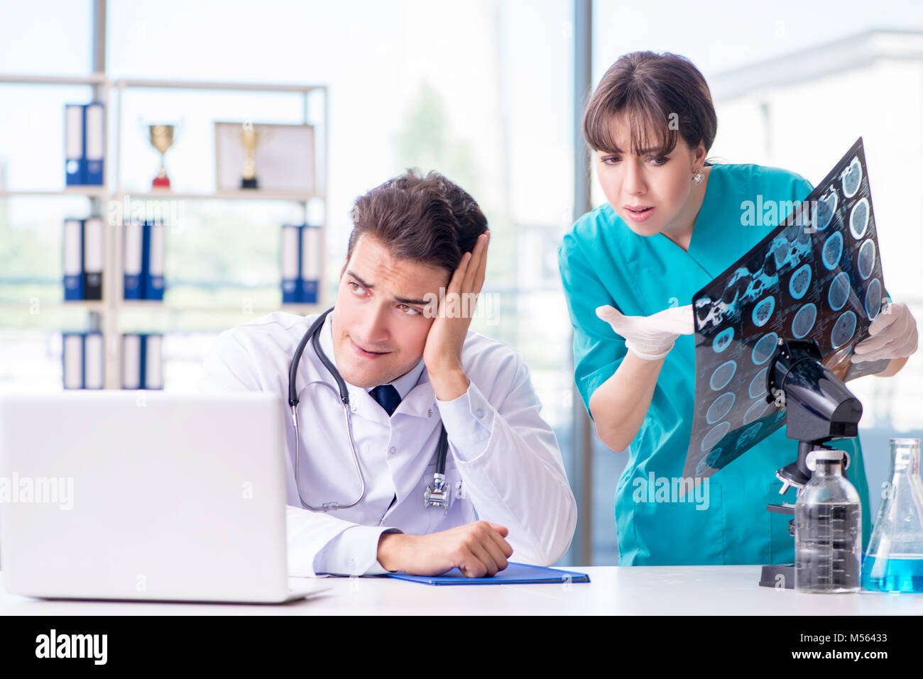 Two doctors discussing x-ray MRI image in hospital Stock Photo - Alamy