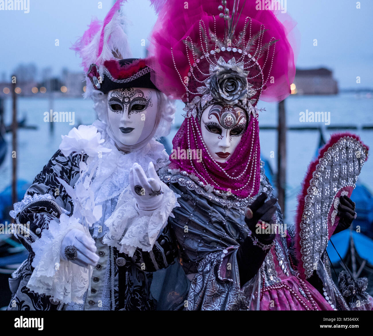 Romantic couple in traditional costume and masks with back to the Grand ...