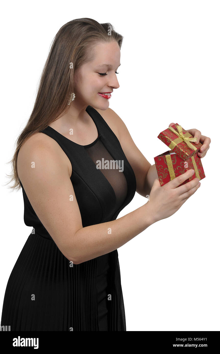 Beautiful woman opening a present Stock Photo - Alamy