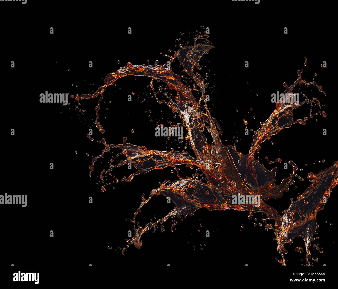 splash of ink isolated on black background. golden splash close-up ...