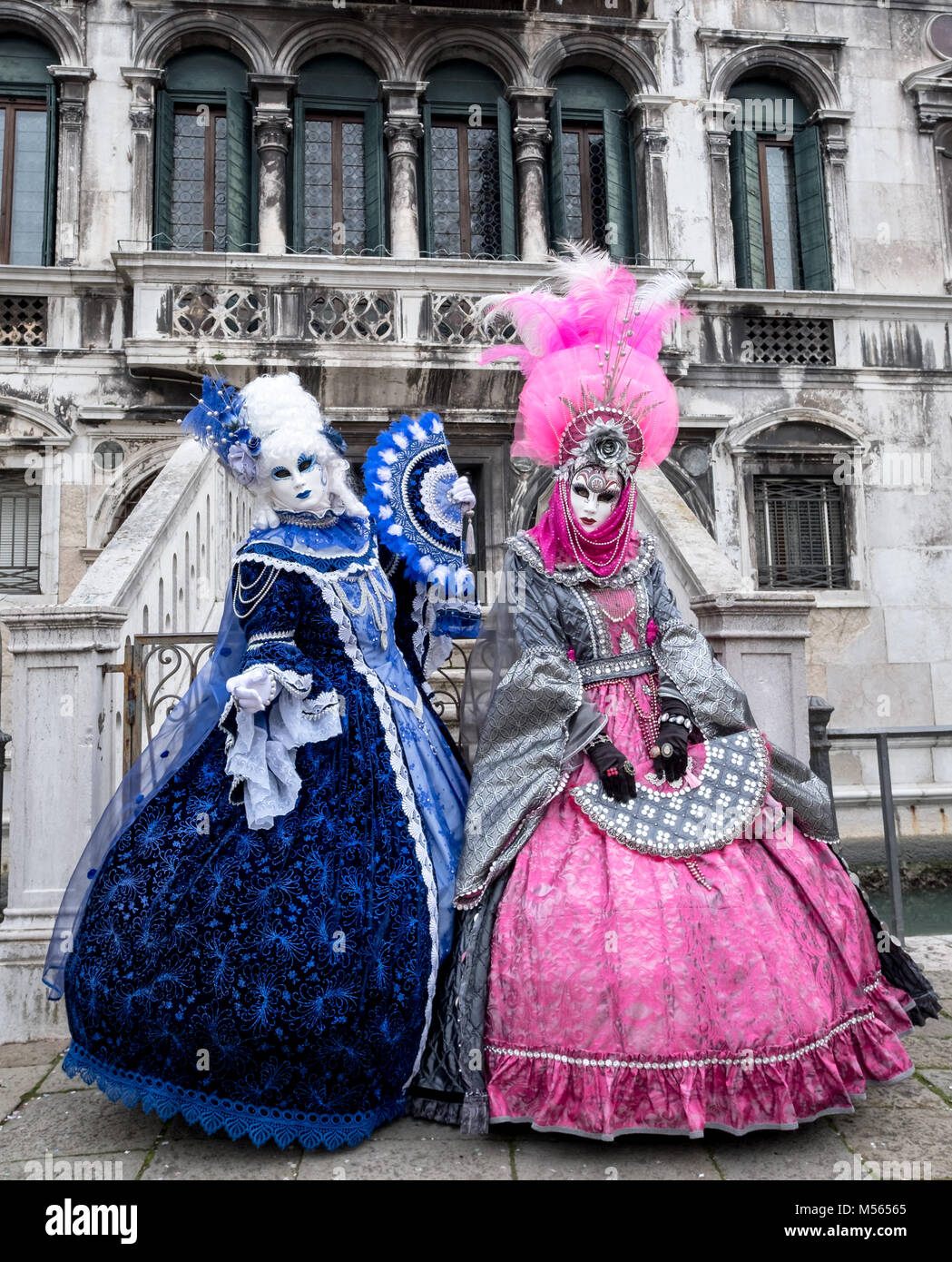 Two masked ladies in blue and pink costumes at Campo di Santa Maria ...
