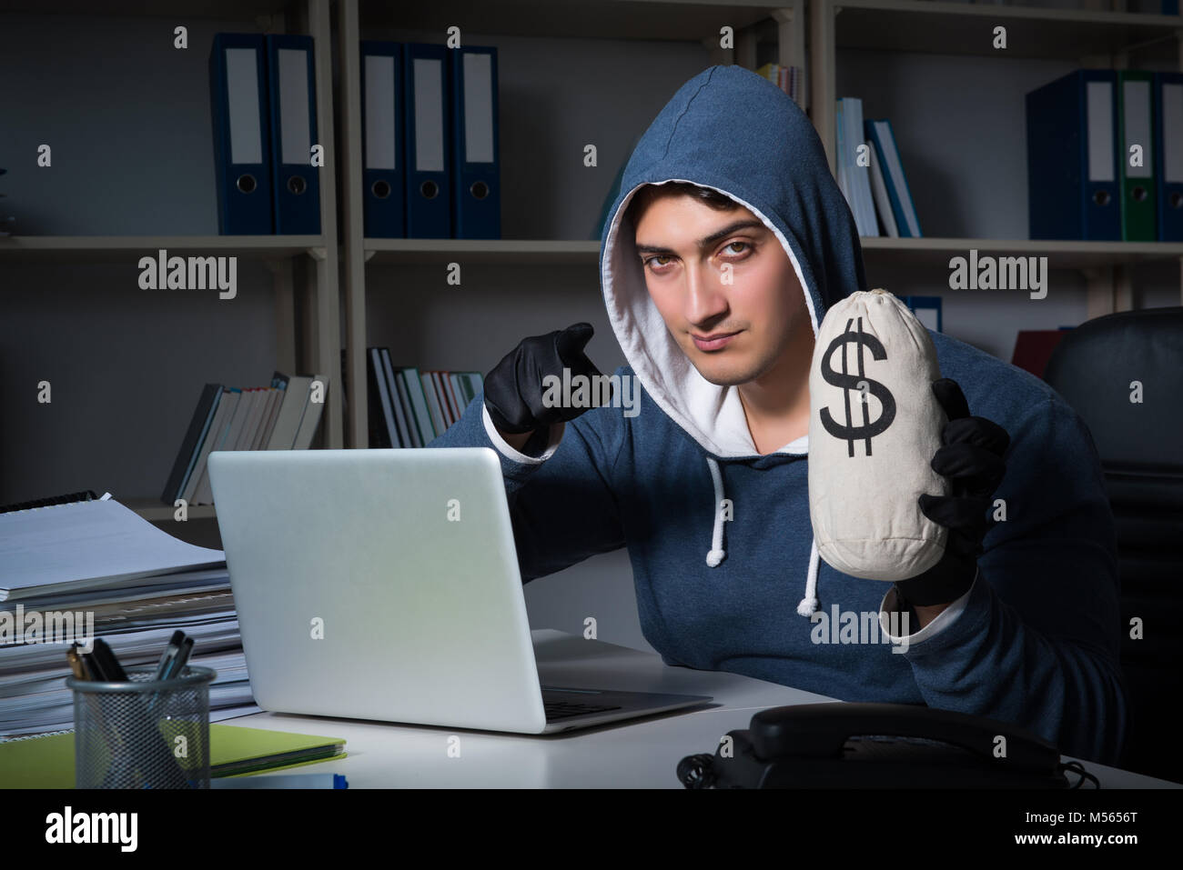 Young hacker hacking into computer at night Stock Photo - Alamy