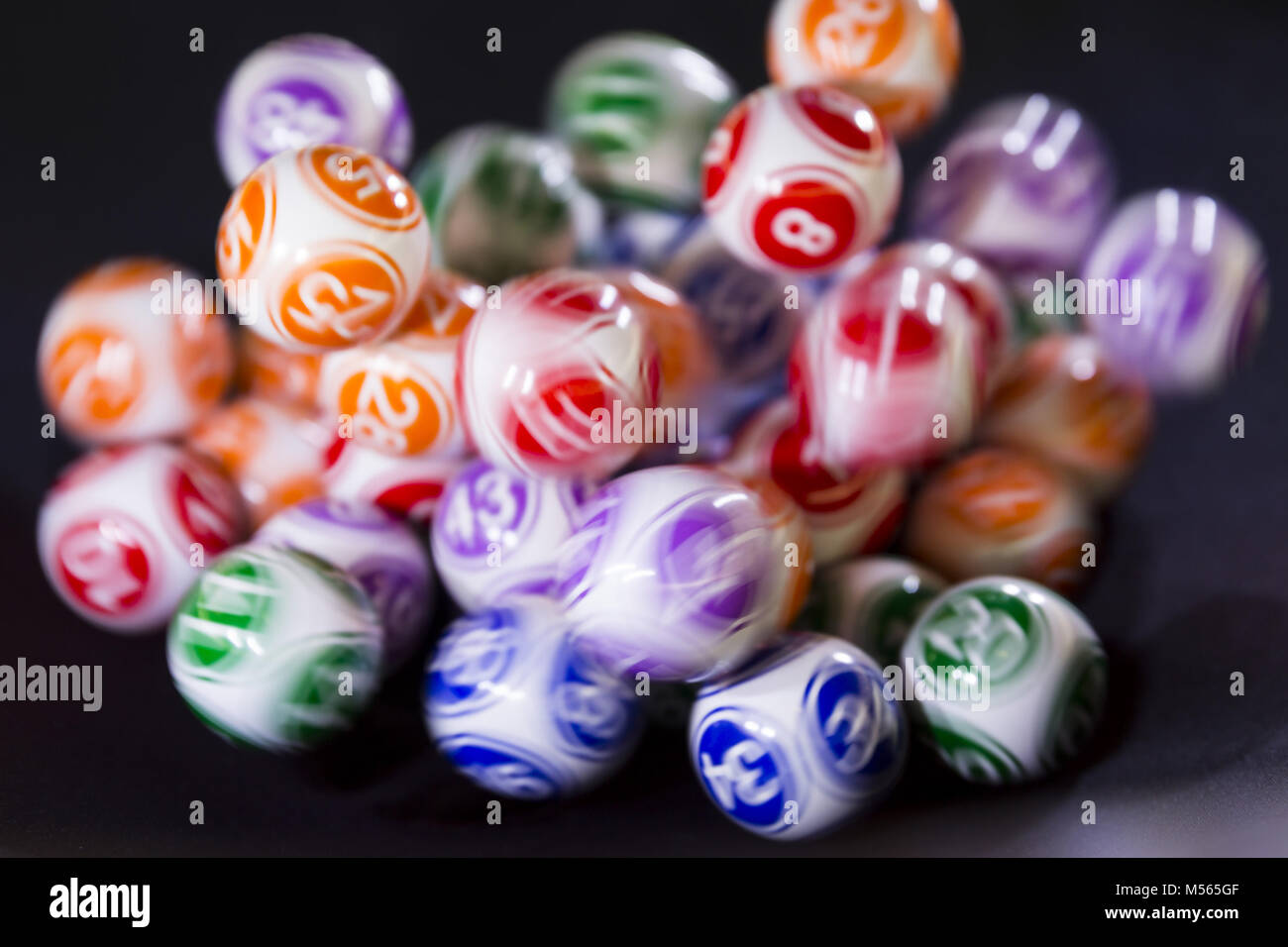Colourful lottery balls in a machine Stock Photo - Alamy