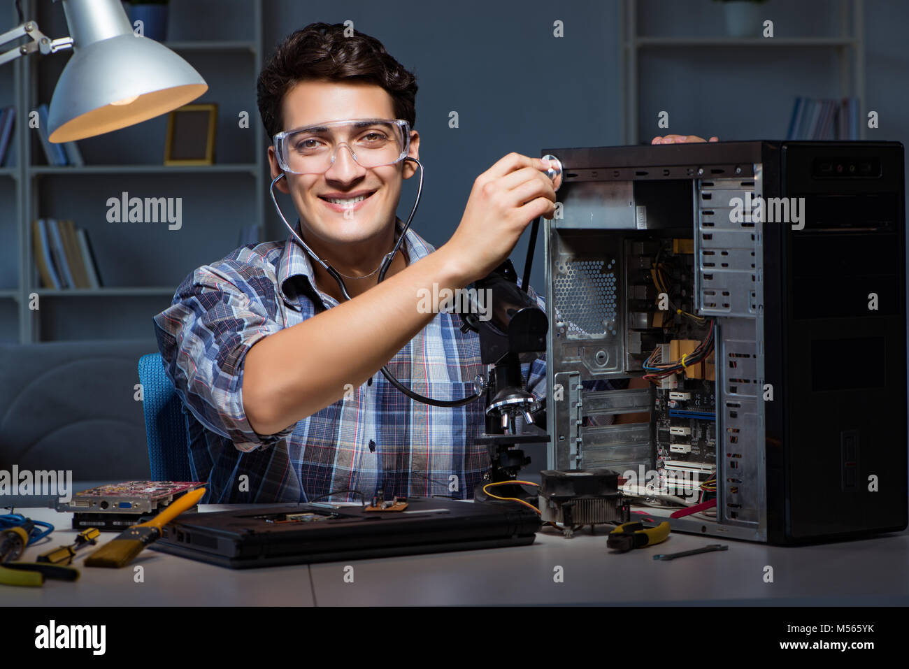 Computer repair concept with man inspecting with stethoscope Stock ...