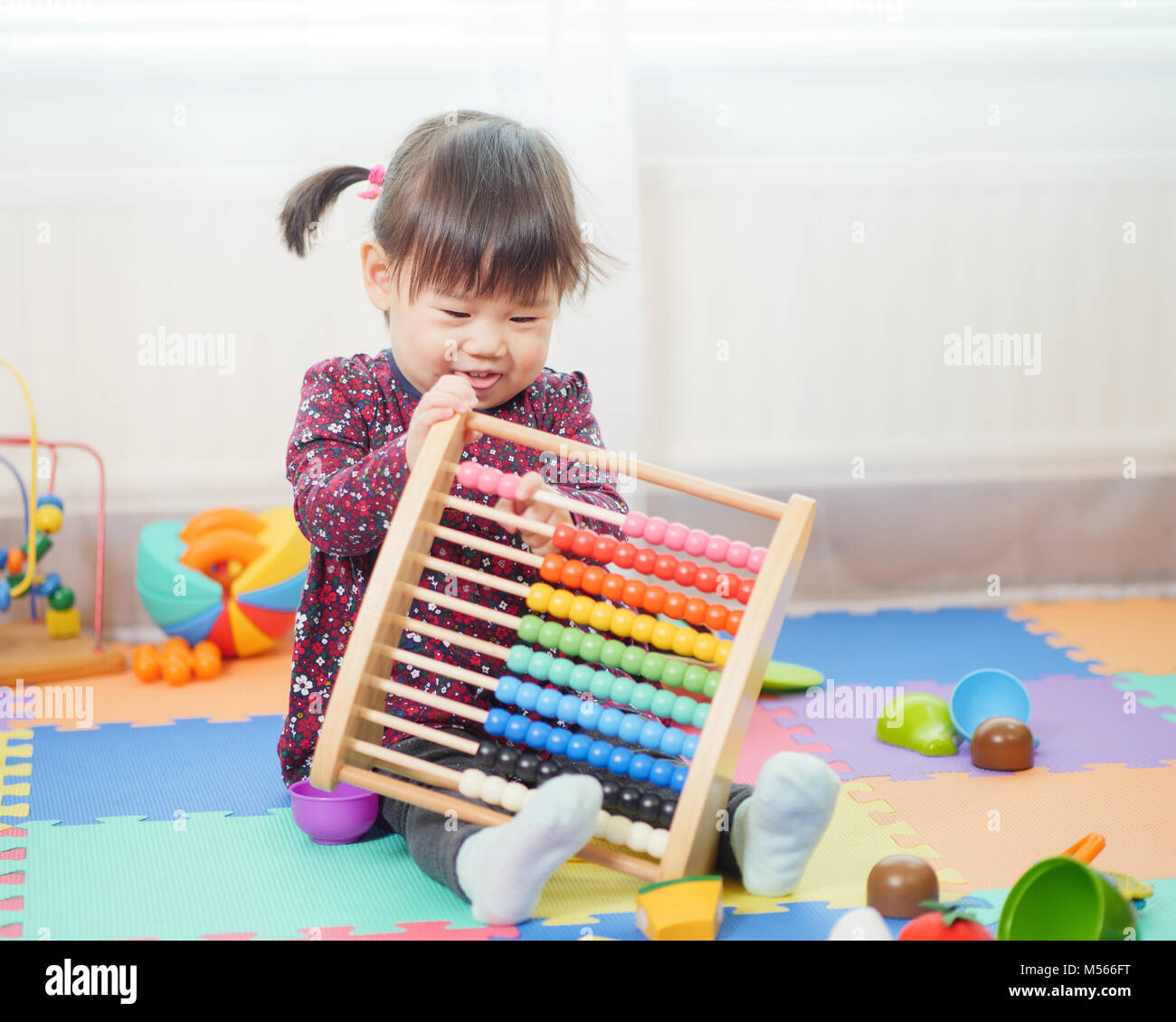 baby girl play abacus at home Stock Photo - Alamy