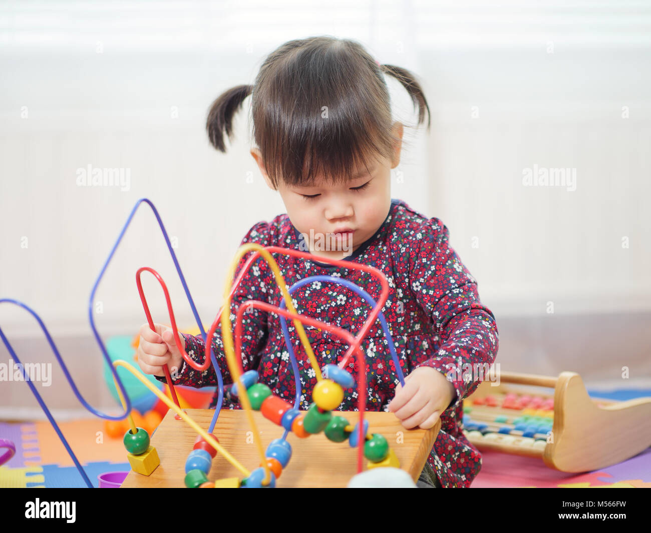baby girl play abacus at home Stock Photo - Alamy