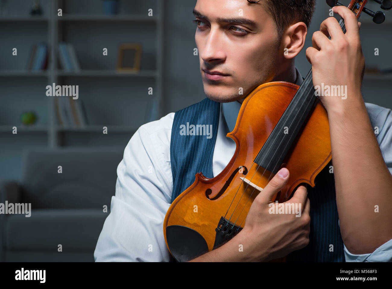 Young musician man practicing playing violin at home Stock Photo - Alamy