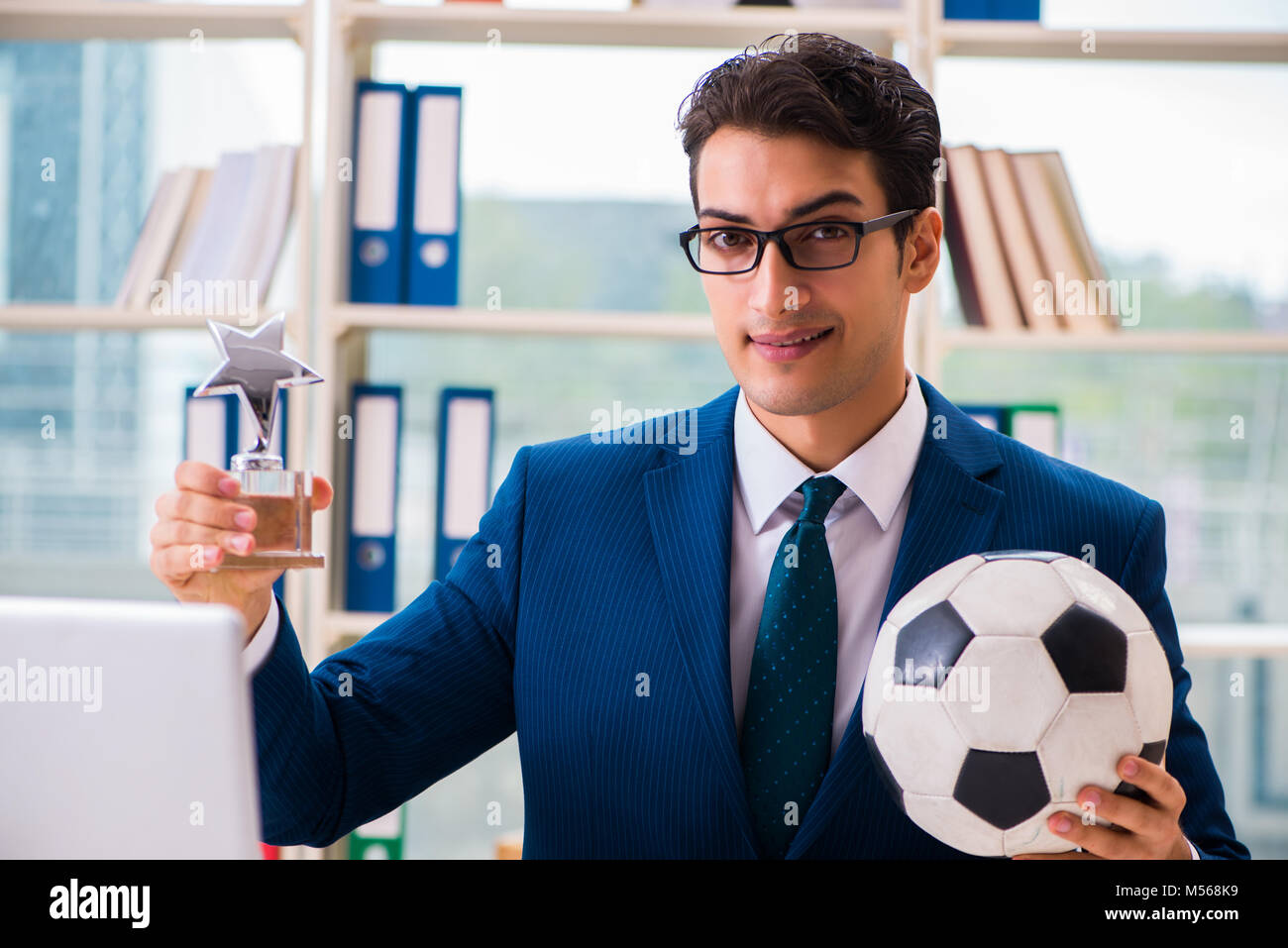 Businessman playing football in the office Stock Photo - Alamy