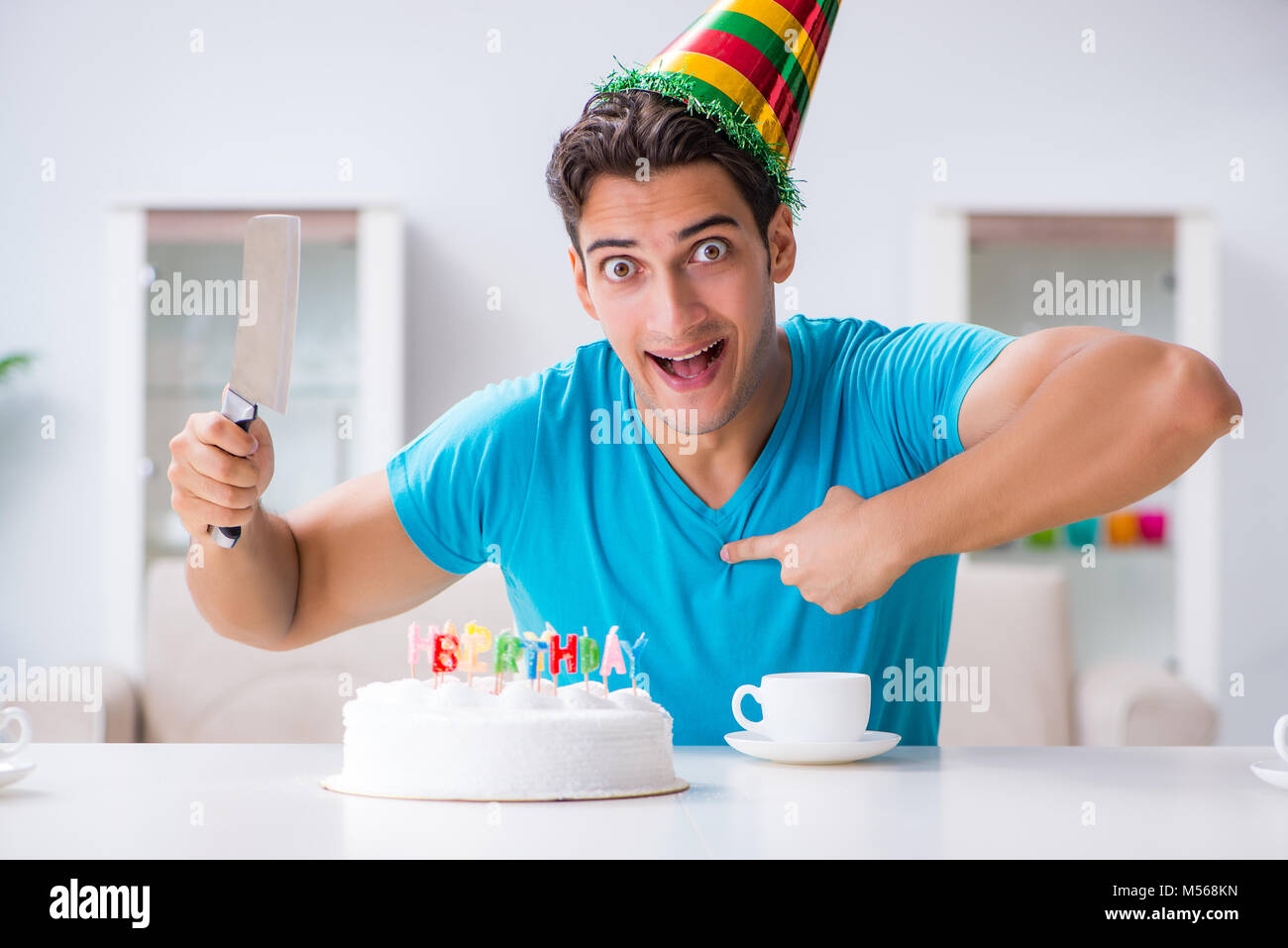 Young man celebrating birthday alone at home Stock Photo - Alamy