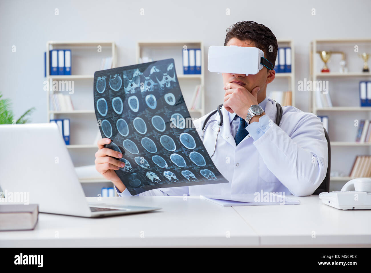 Young doctor looking at MRI scan through VR glasses Stock Photo - Alamy