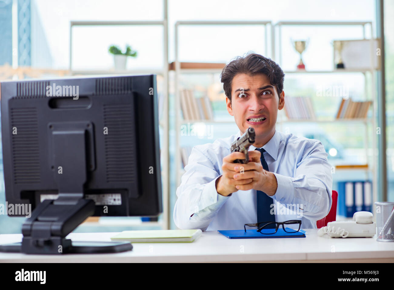 Angry businessman with gun thinking of committing suicide Stock Photo ...