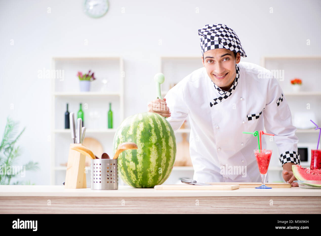 Male cook with watermelon in kitchen Stock Photo - Alamy