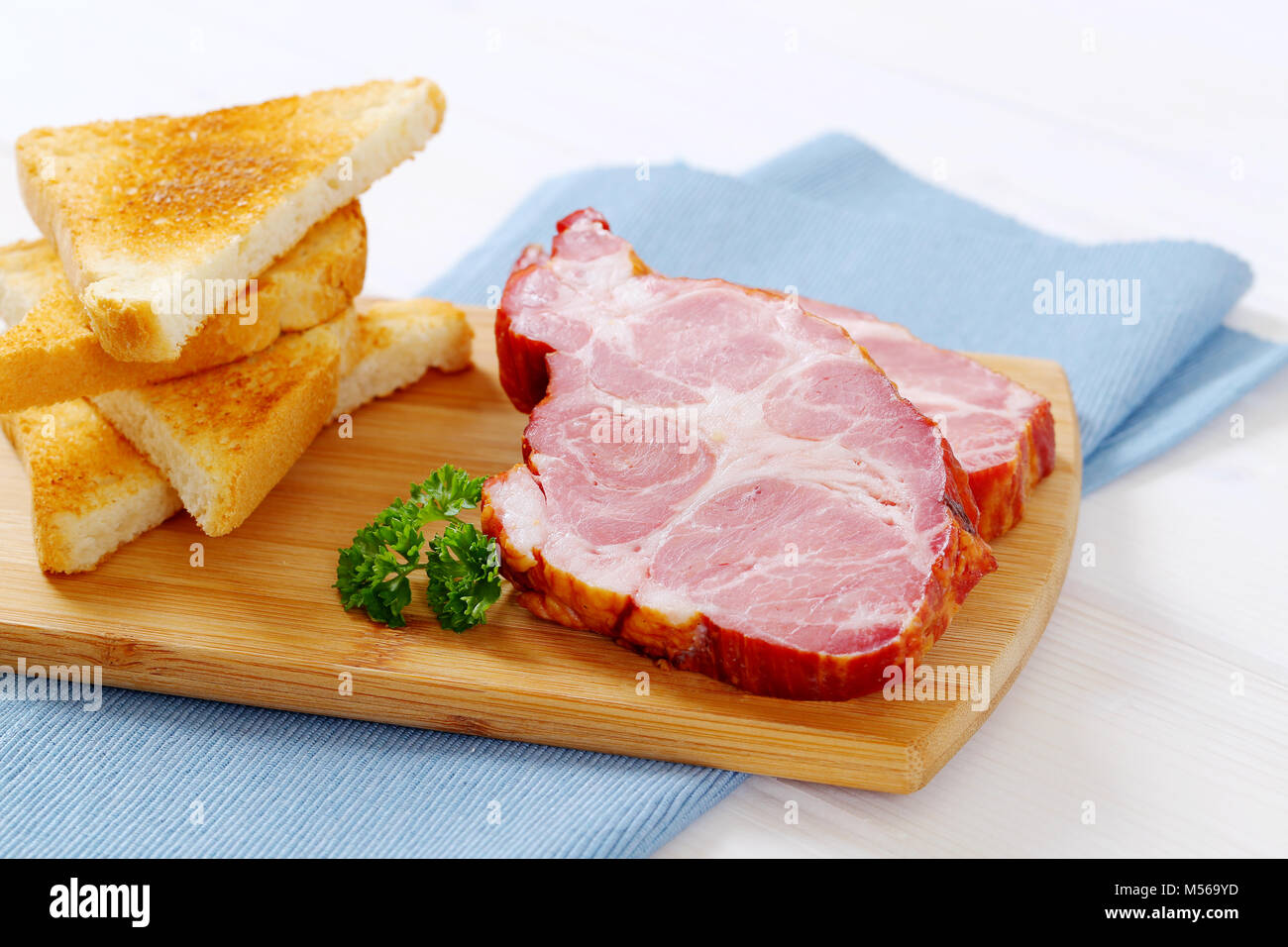 smoked pork with toasted bread on wooden cutting board Stock Photo - Alamy