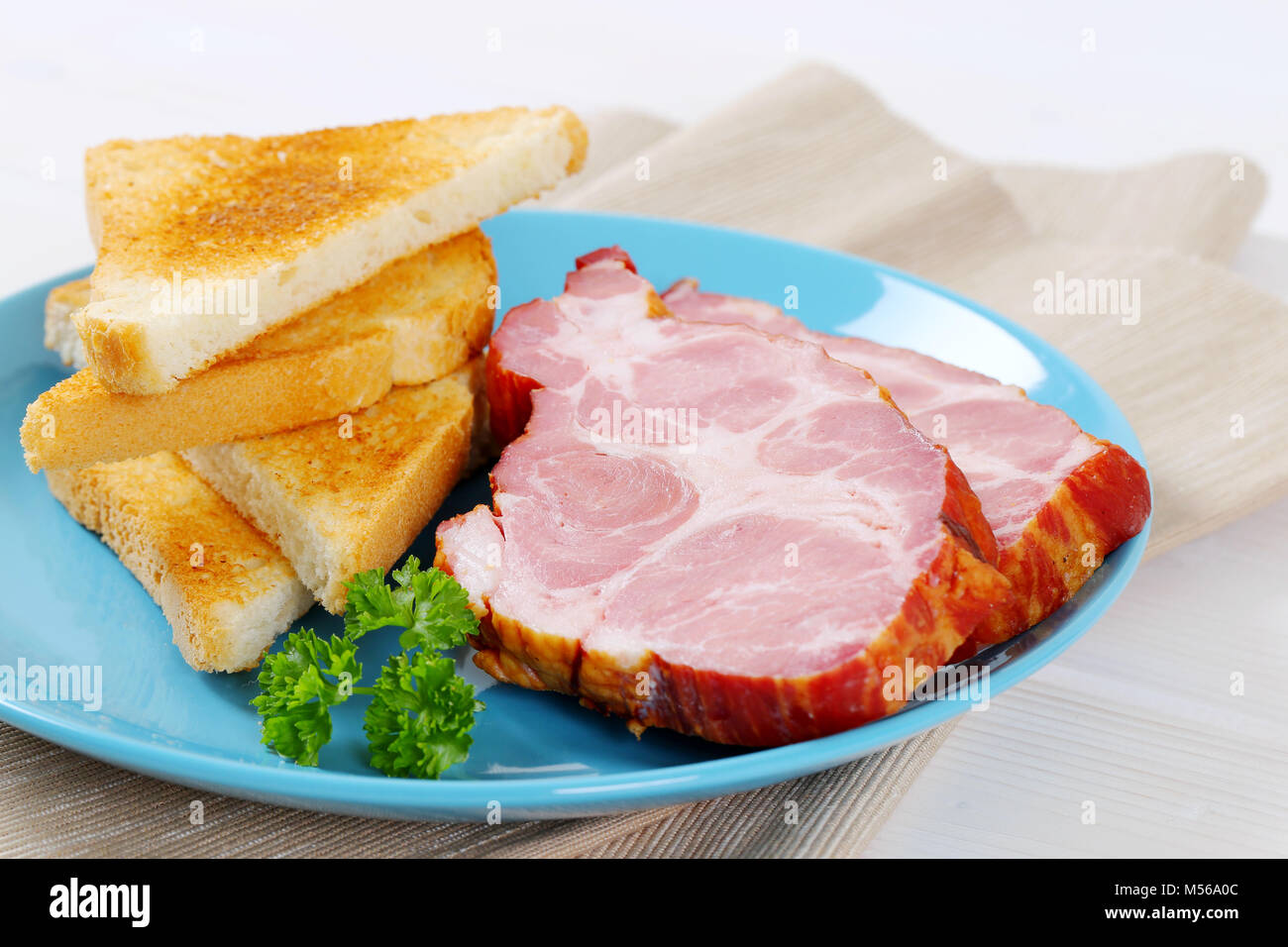 smoked pork with toasted bread on turquoise plate Stock Photo - Alamy