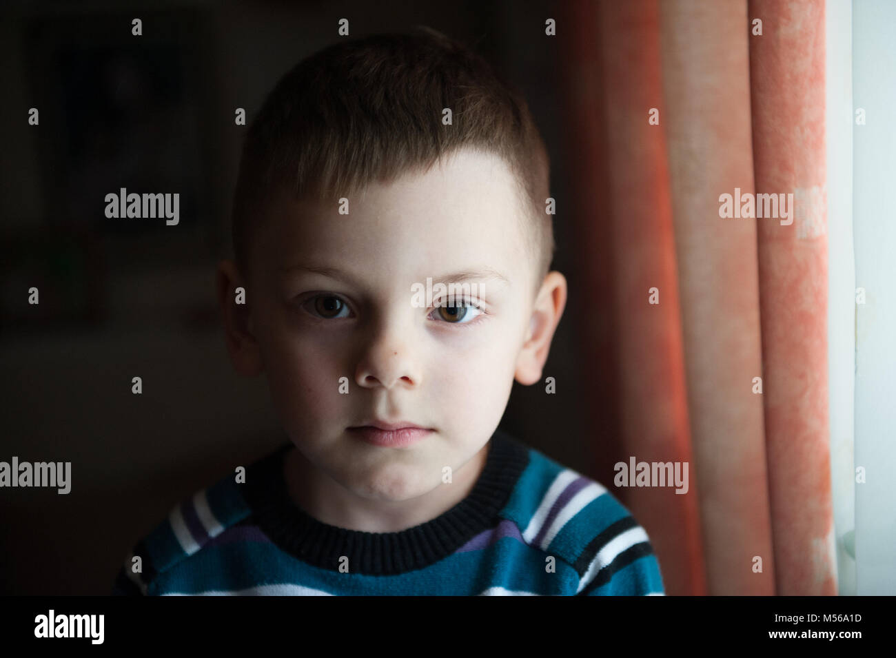portrait of cute pensive little boy by the window Stock Photo - Alamy