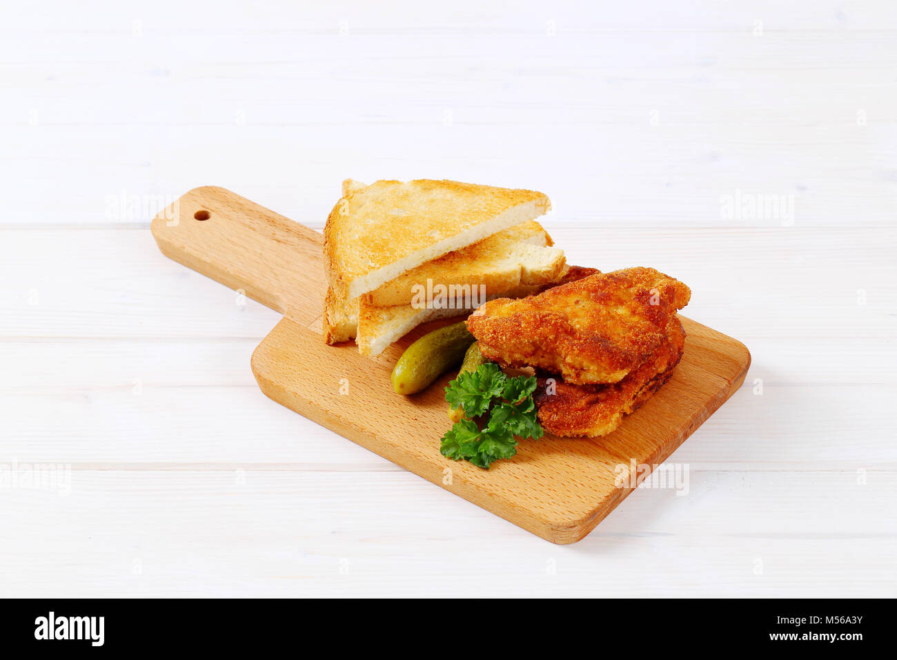Wiener schnitzels with toasted bread on cutting board Stock Photo - Alamy