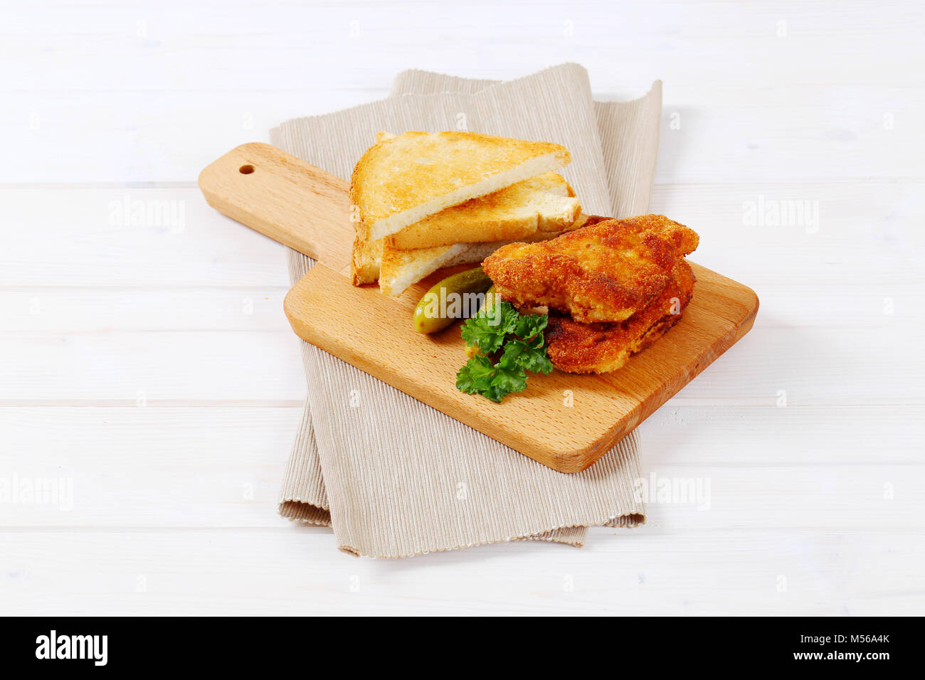 Wiener schnitzels with toasted bread on cutting board Stock Photo - Alamy