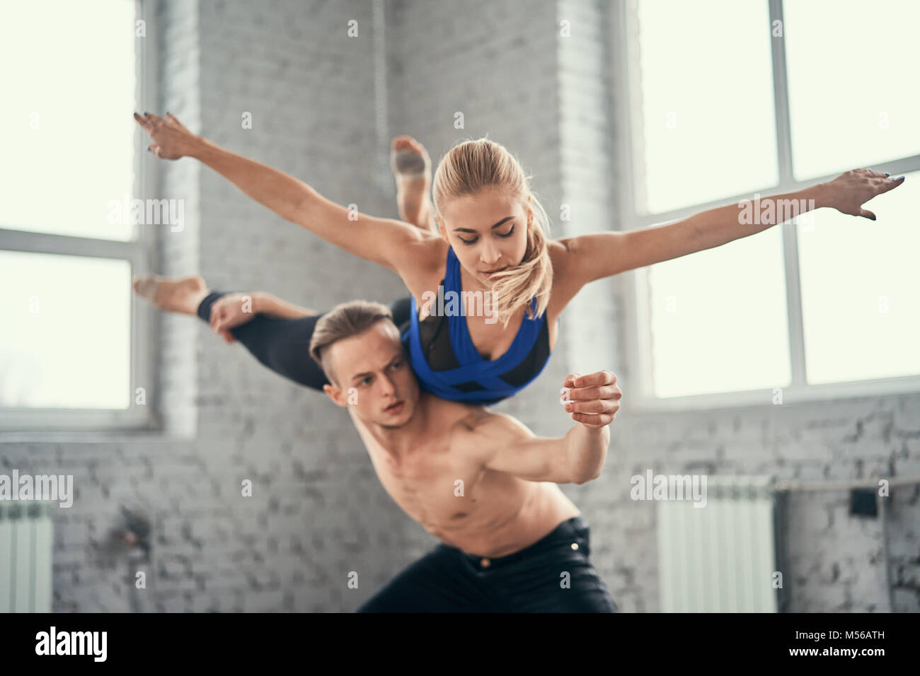 A young couple of dancers perform complex tricks Stock Photo - Alamy