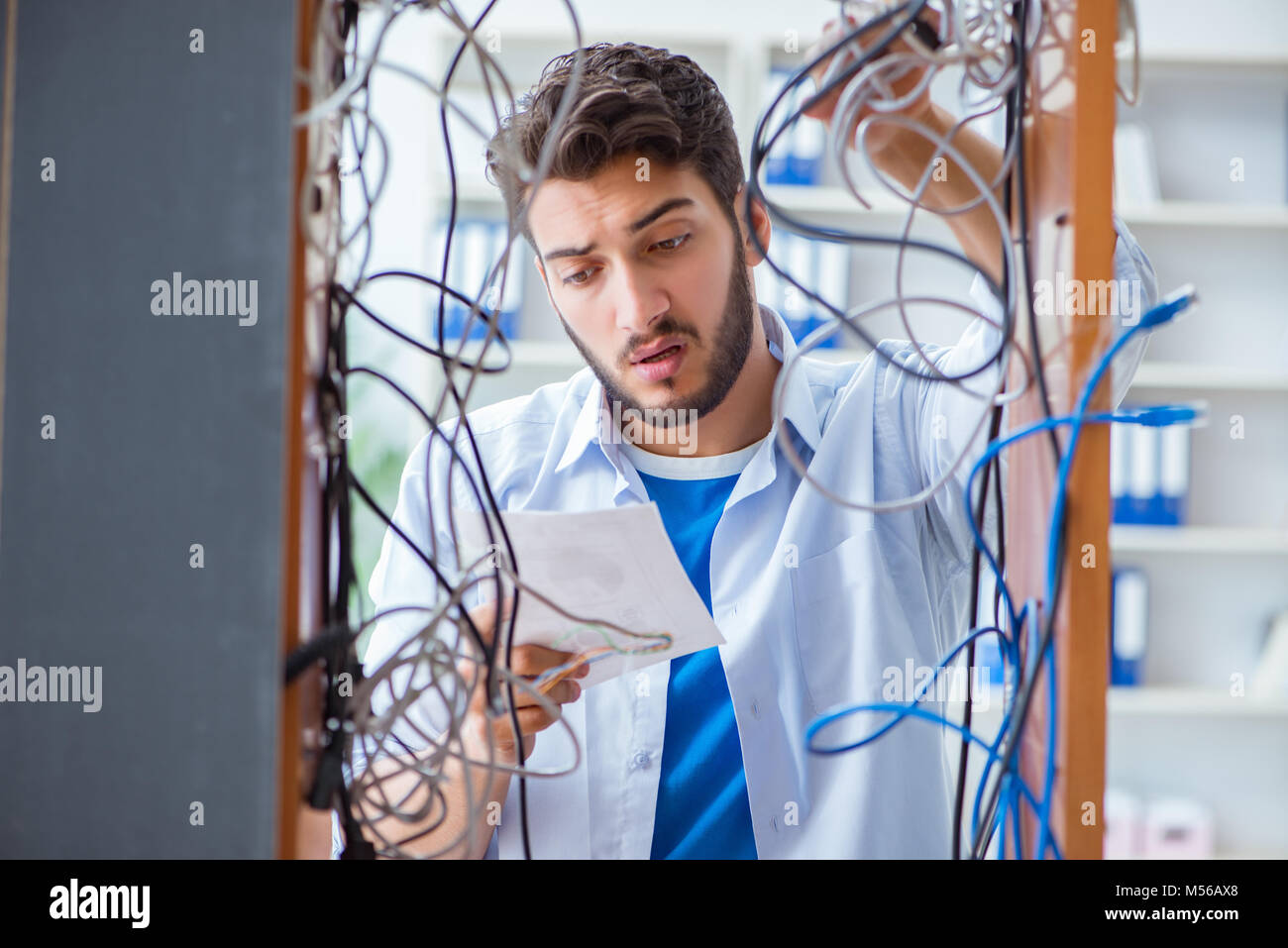 Computer repairman working on repairing network in IT workshop Stock ...