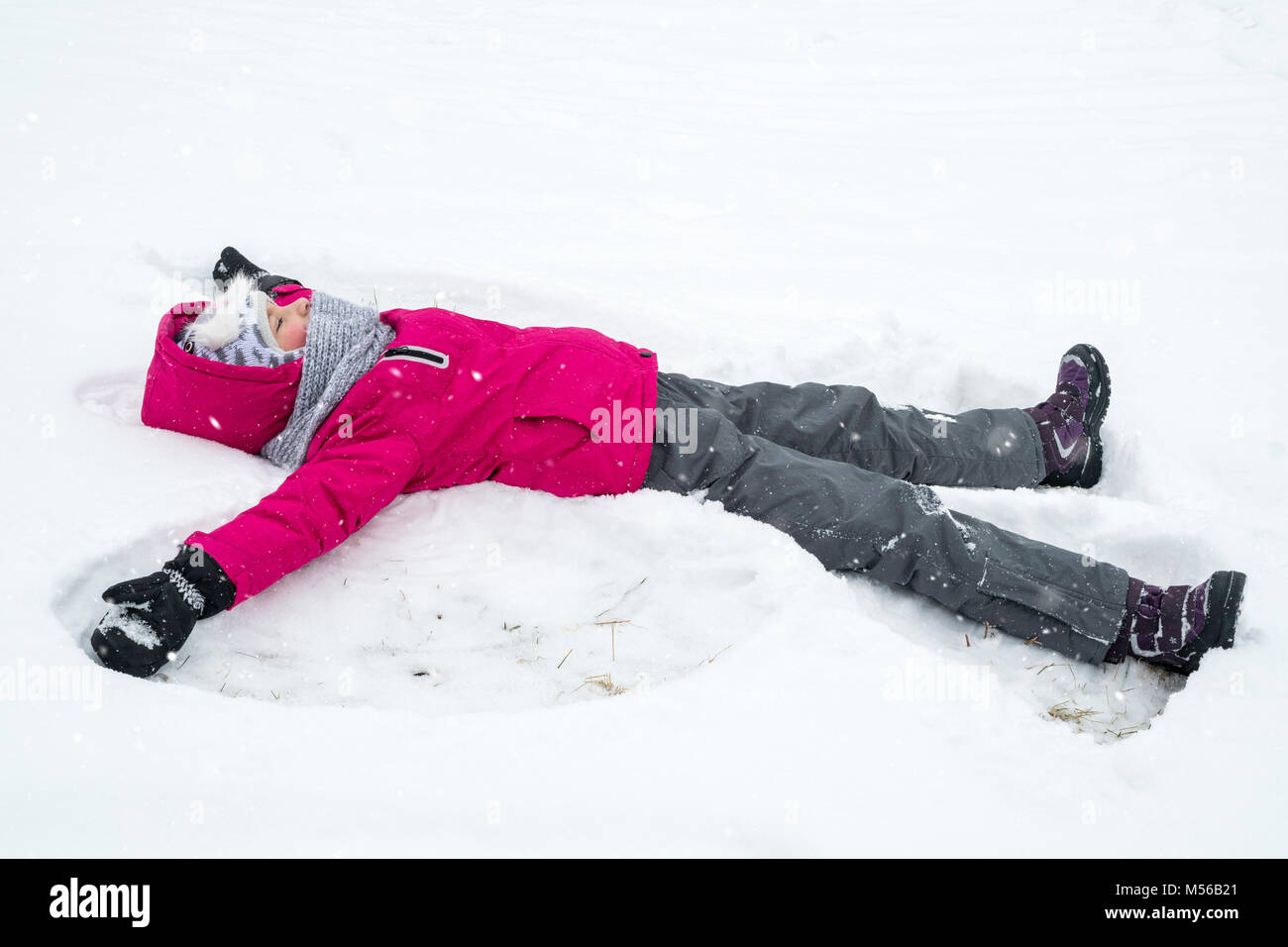 Girl making angel in snow hi-res stock photography and images - Alamy