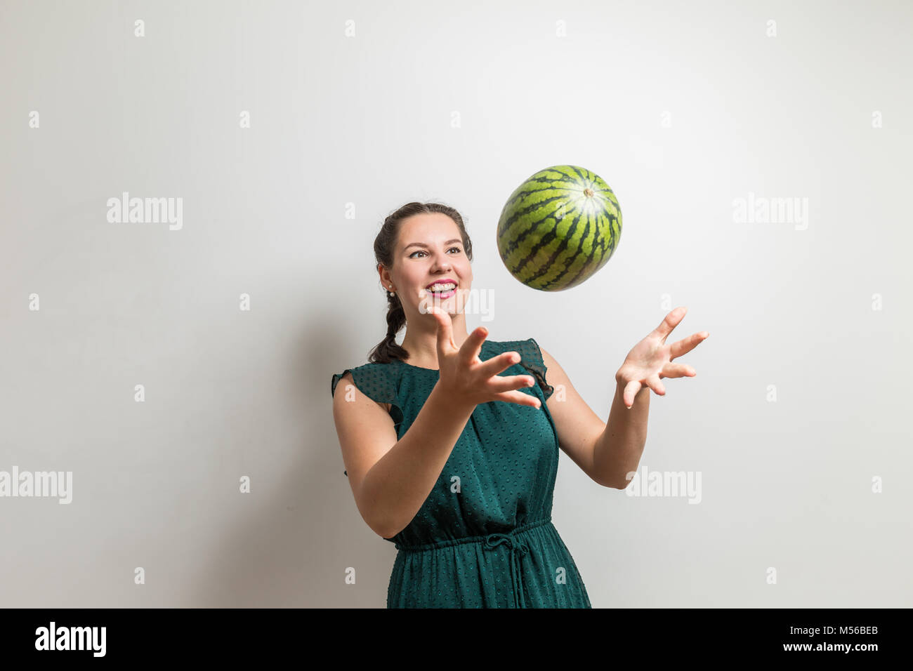 Smiling teenager throws a watermelon Stock Photo - Alamy
