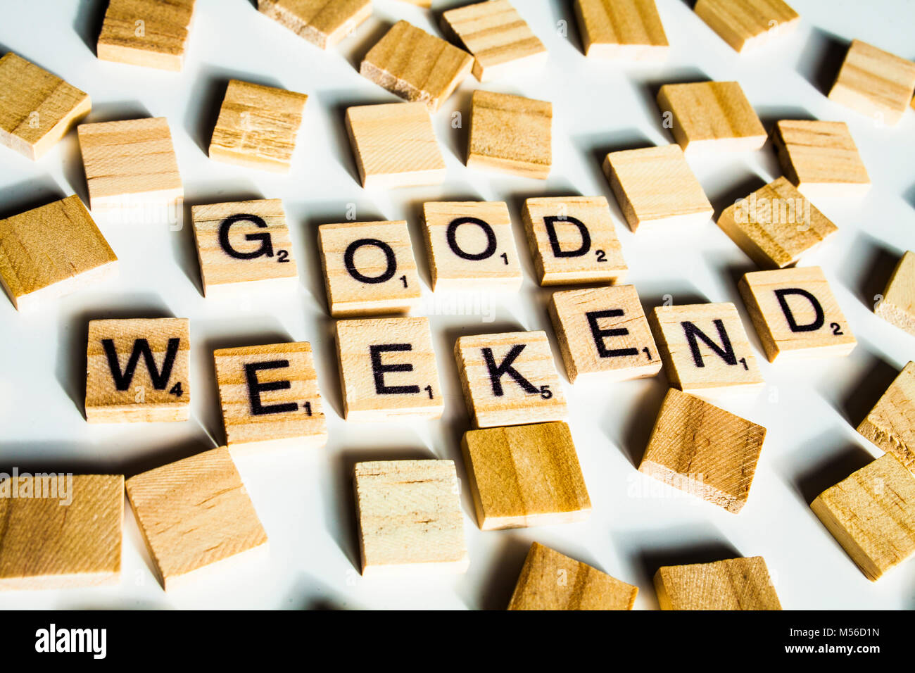 WORD GOOD WEEKEND. Wooden letters spelling the word GOOD WEEKEND on ...