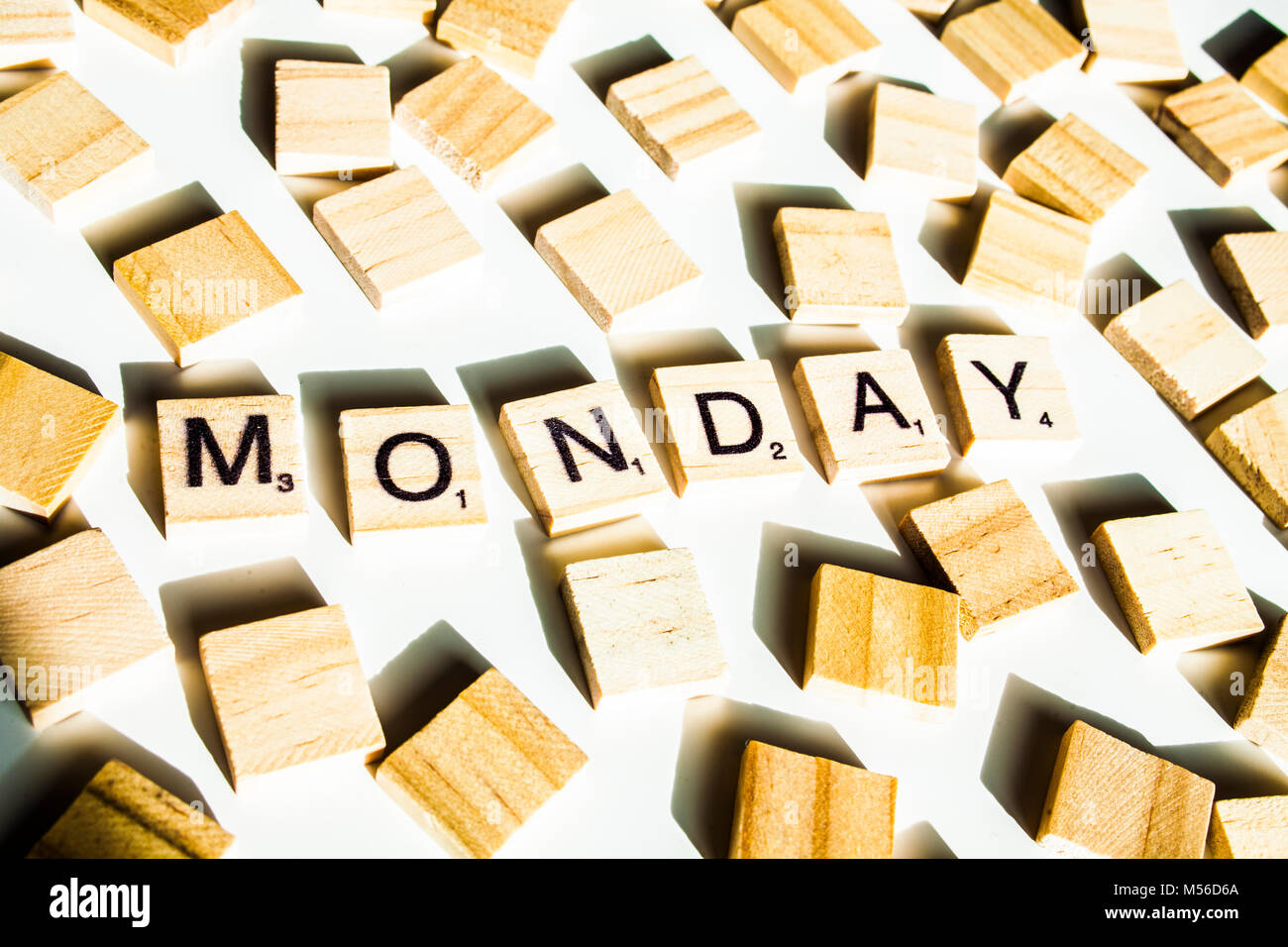 WORD MONDAY. Wooden letters spelling the word MONDAY on white ...