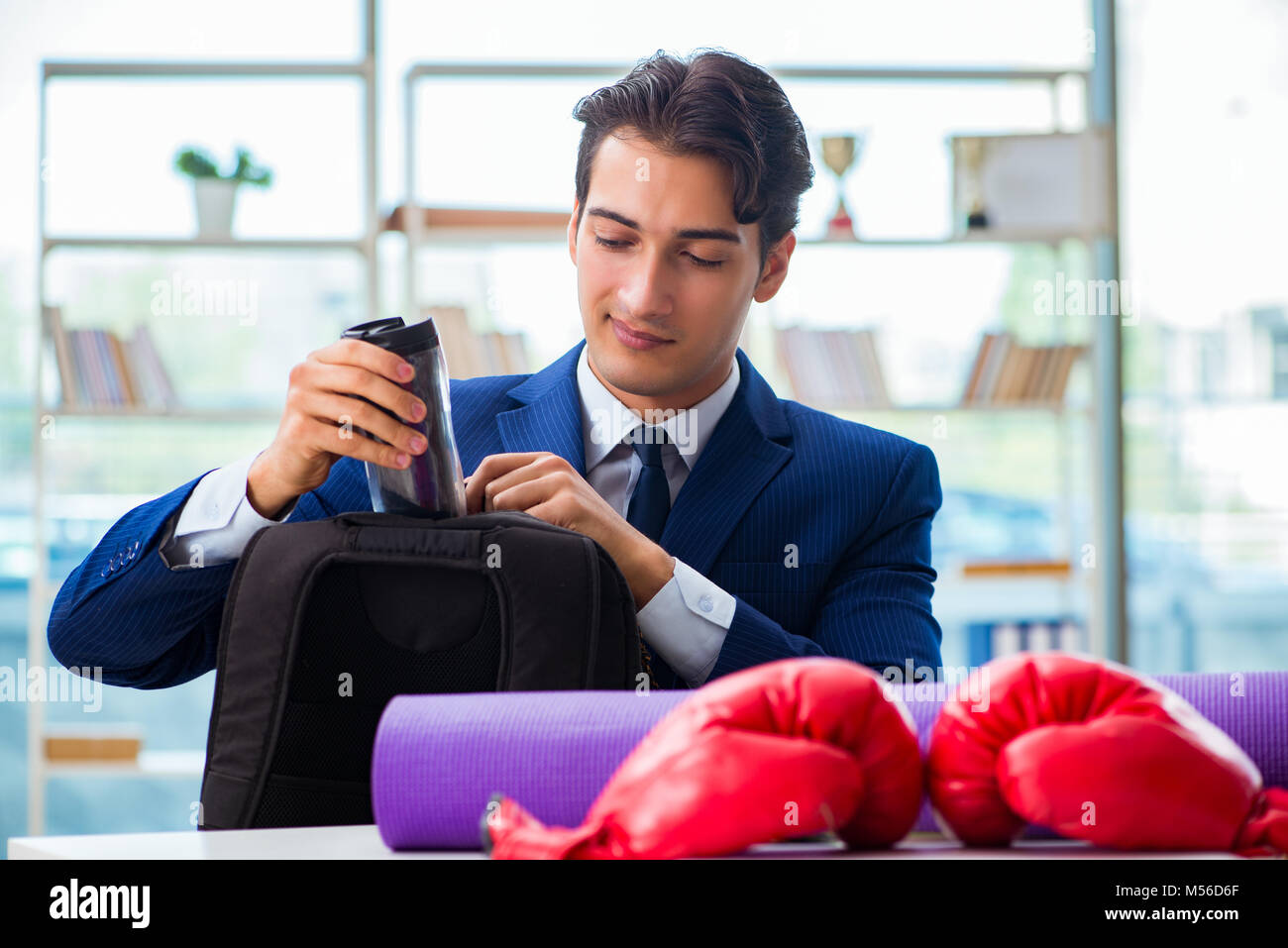 Man with boxing gloves in the office Stock Photo - Alamy