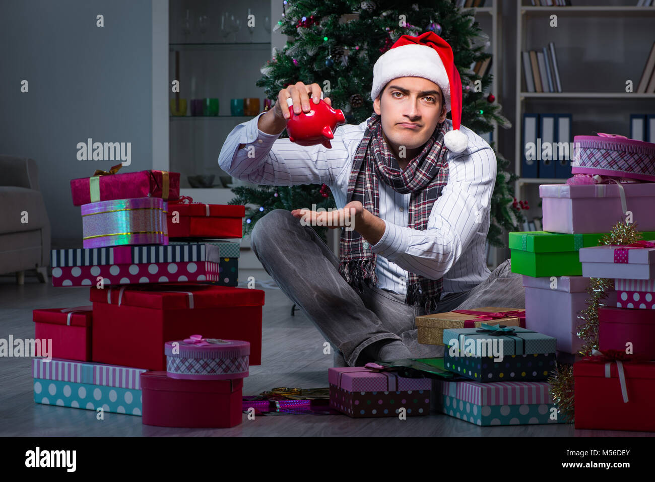 Man with many christmas gifts in boxes Stock Photo - Alamy