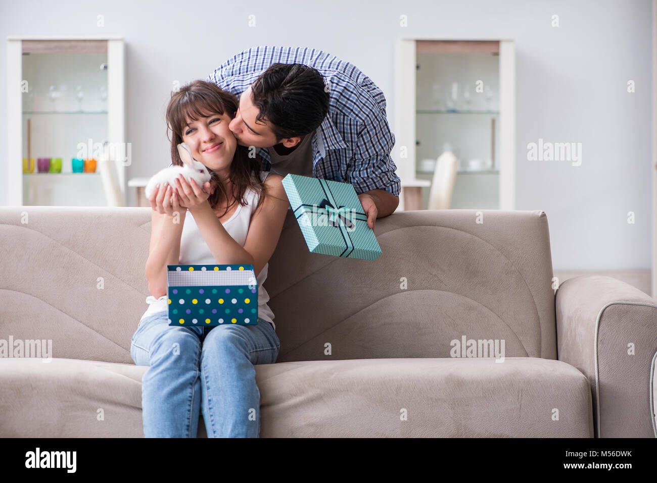 Young woman getting pet rabbit as birthday present Stock Photo - Alamy